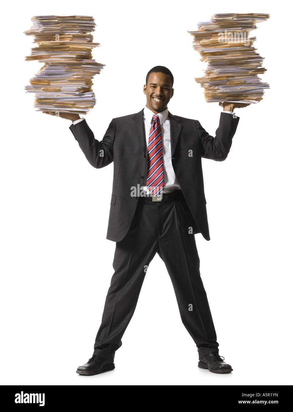 Man holding stacks of paperwork smiling Stock Photo - Alamy