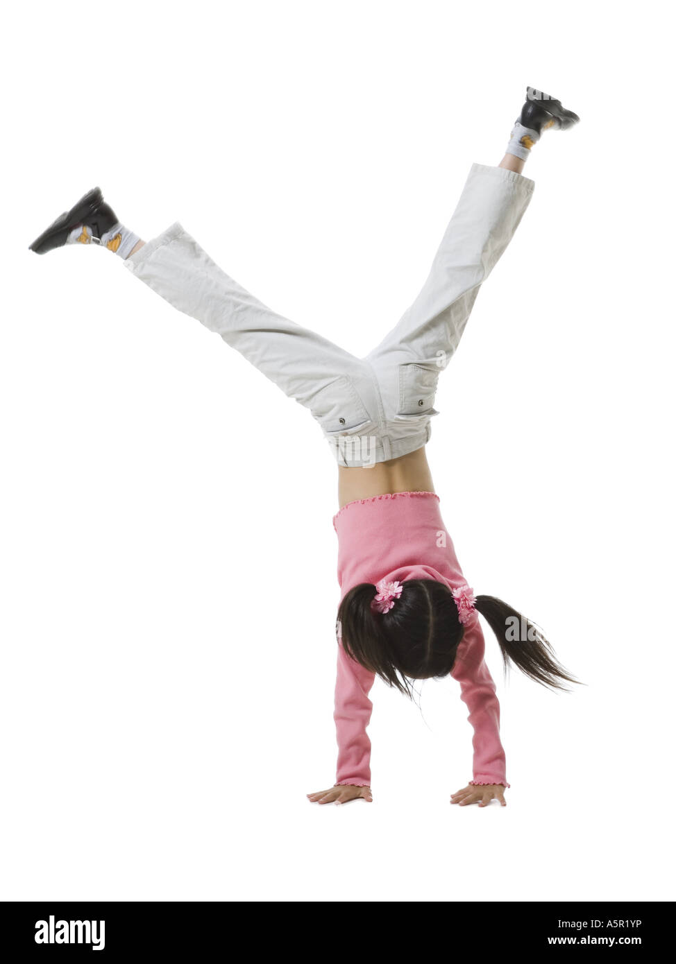 Portrait of a girl doing a hand stand Stock Photo - Alamy