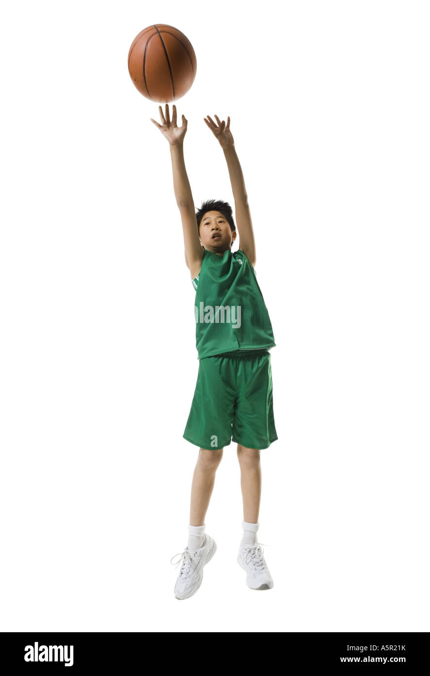 Boy throwing a basketball Stock Photo - Alamy