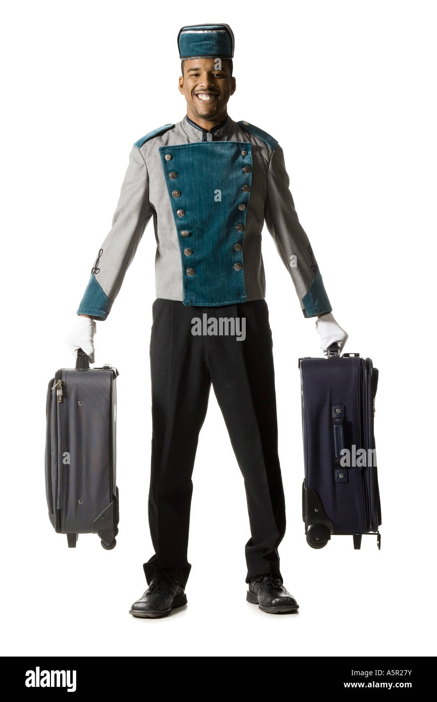 Bellboy with luggage smiling Stock Photo - Alamy