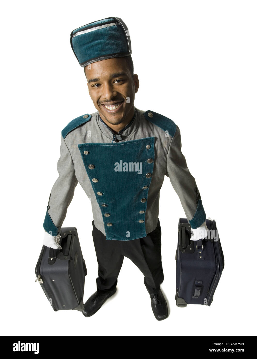 Bellboy with luggage smiling Stock Photo - Alamy