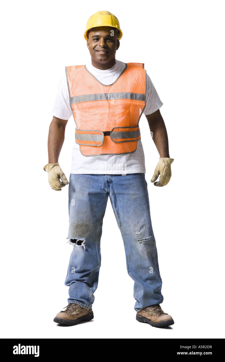 Male road worker with crossed arms and hardhat smiling Stock Photo - Alamy