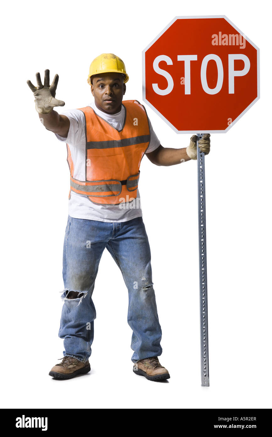 Road worker holding stop sign Cut Out Stock Images & Pictures - Alamy