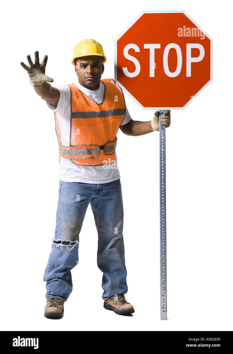 Road worker with stop sign and hardhat Stock Photo - Alamy