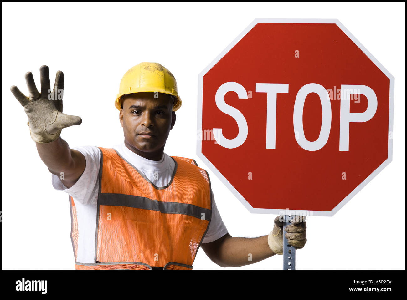 Road worker with stop sign and hardhat Stock Photo - Alamy