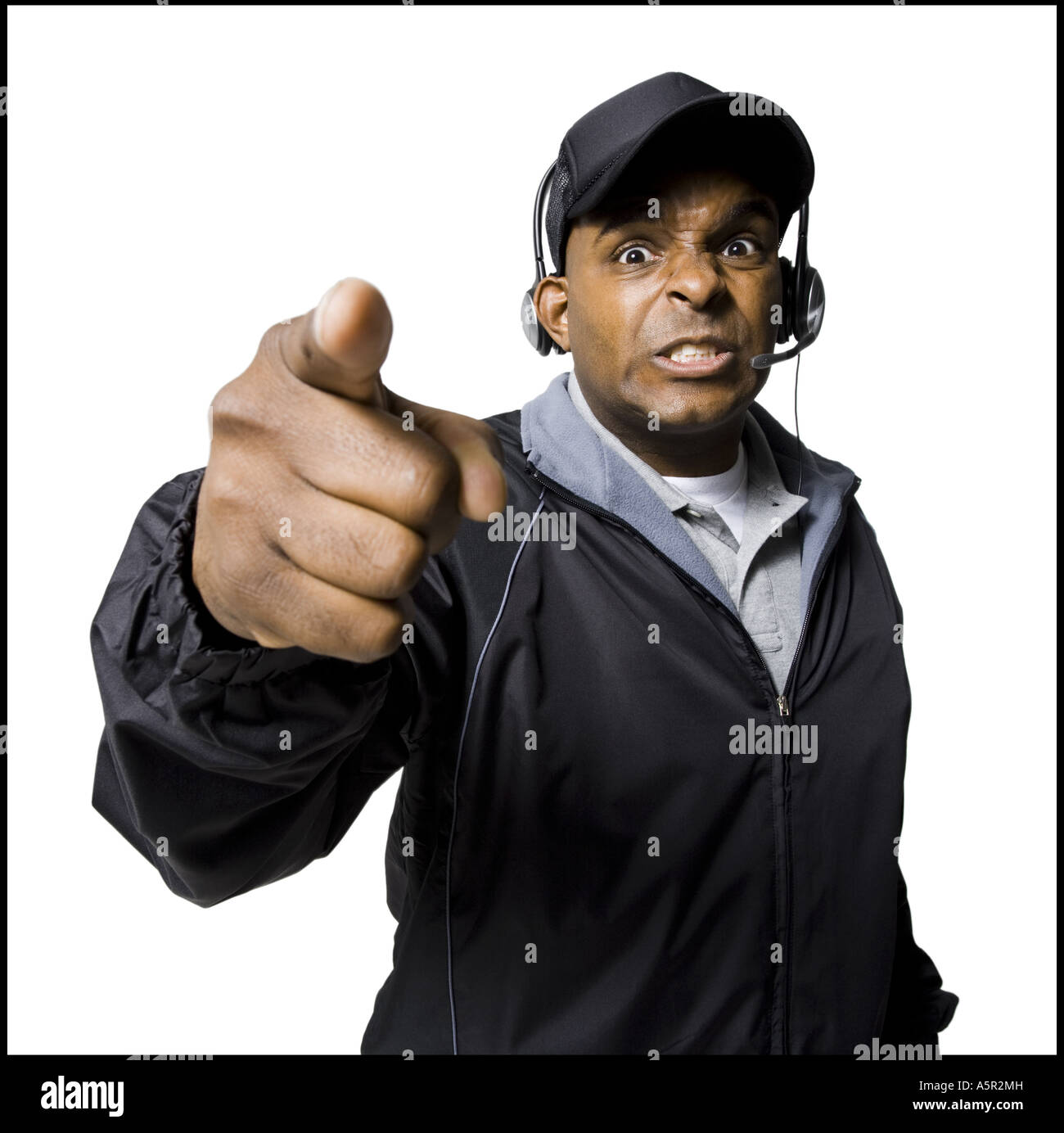 Male head coach pointing finger with headset Stock Photo - Alamy