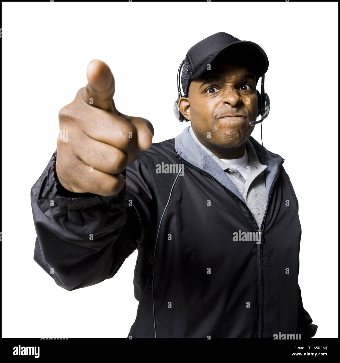 Male head coach pointing finger with headset Stock Photo - Alamy