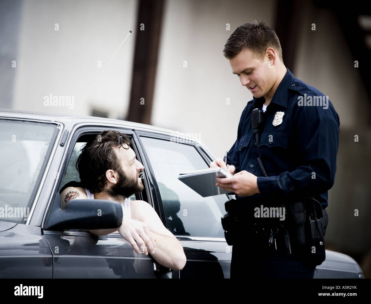 Traffic cop writing ticket to male driver with cigarette Stock Photo ...