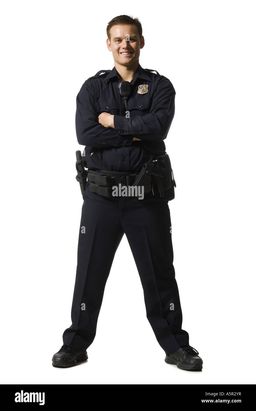 Male police officer standing with arms crossed smiling Stock Photo - Alamy