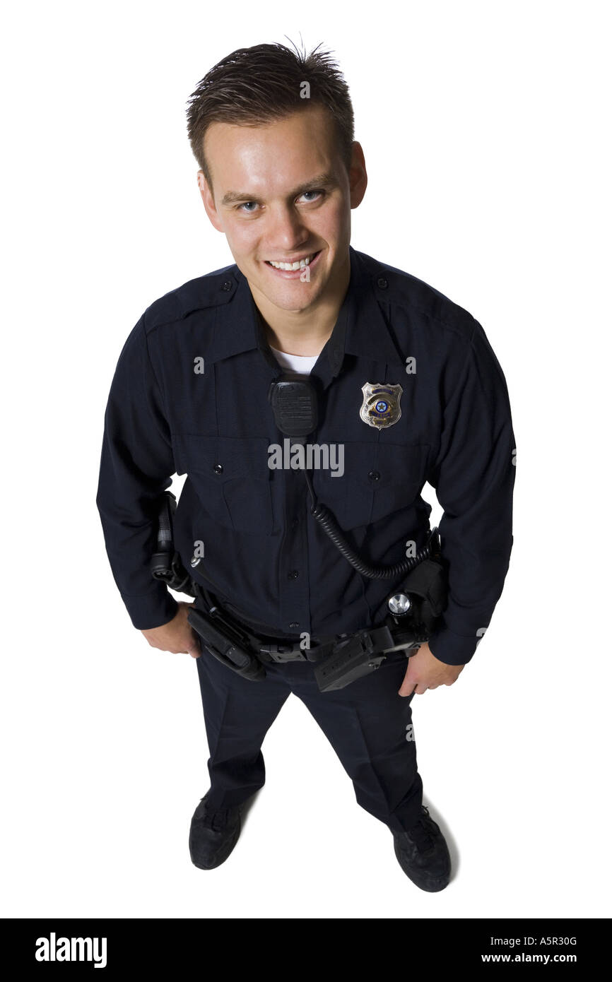 Male police officer standing with arms crossed smiling Stock Photo - Alamy