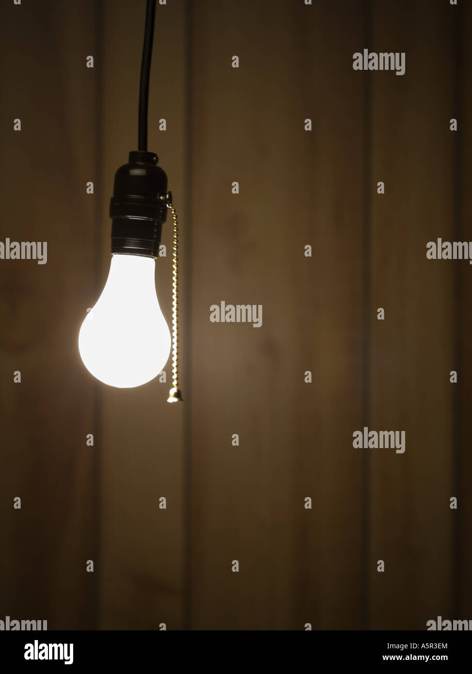 Lightbulb hanging from ceiling Stock Photo - Alamy