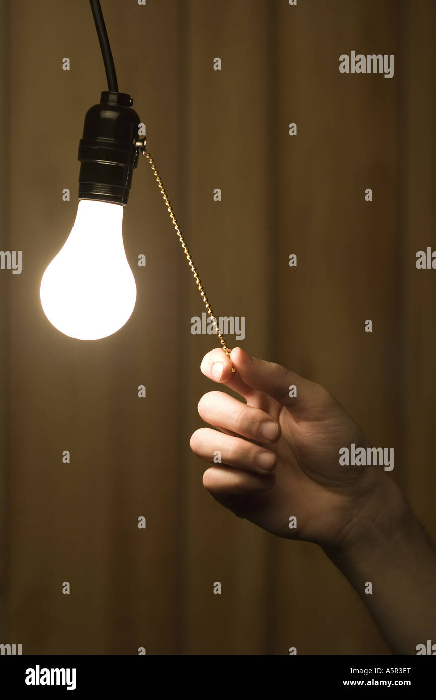 Man pulling light switch Stock Photo - Alamy