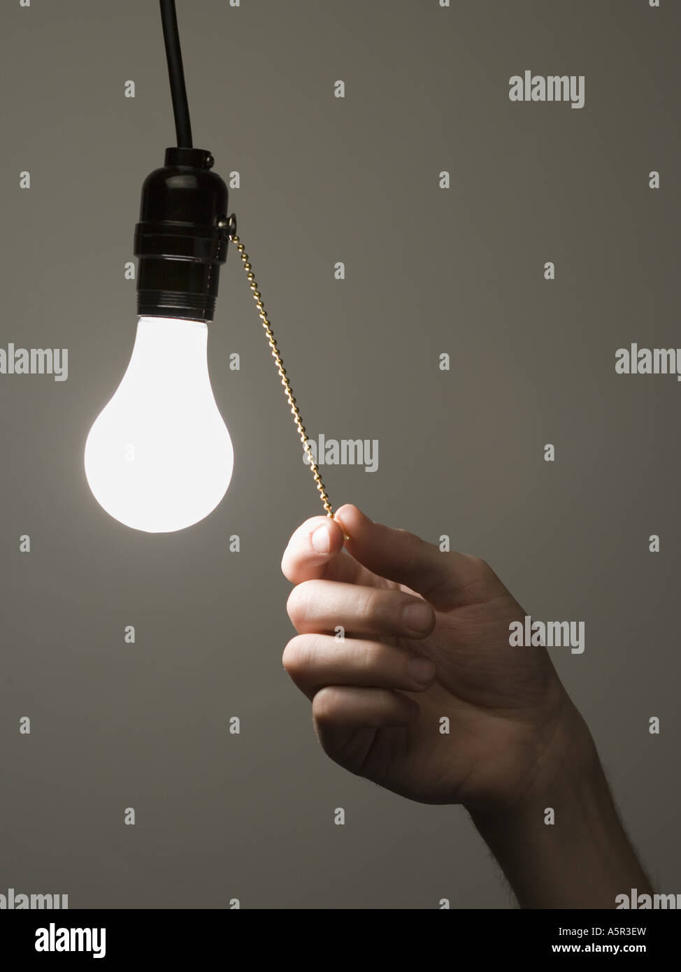 Man pulling light switch Stock Photo - Alamy
