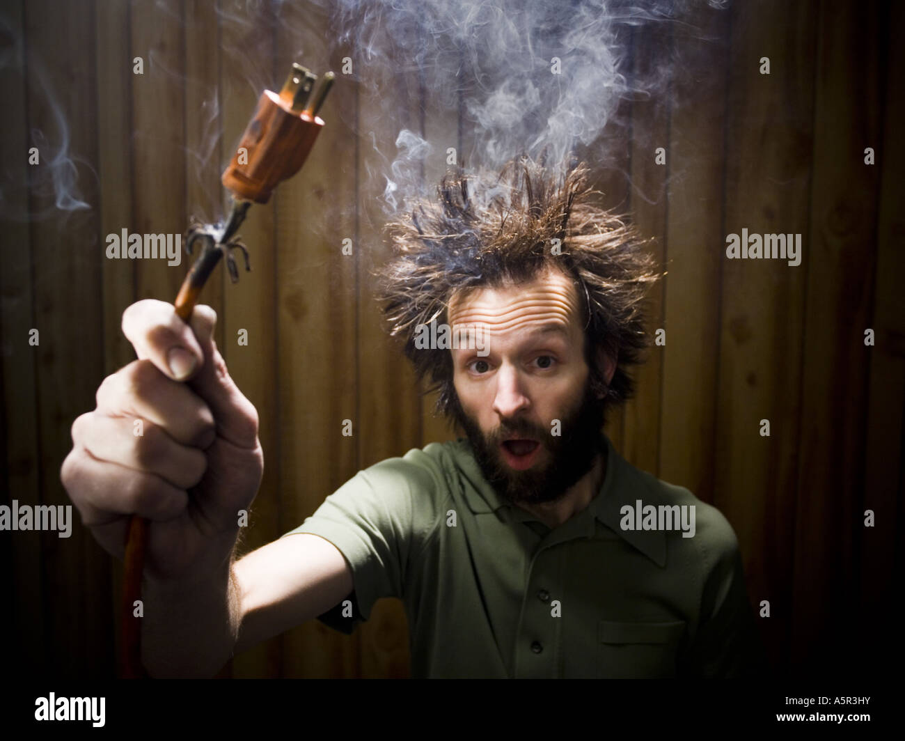 Man after electric shock with electric plug and smoke Stock Photo - Alamy