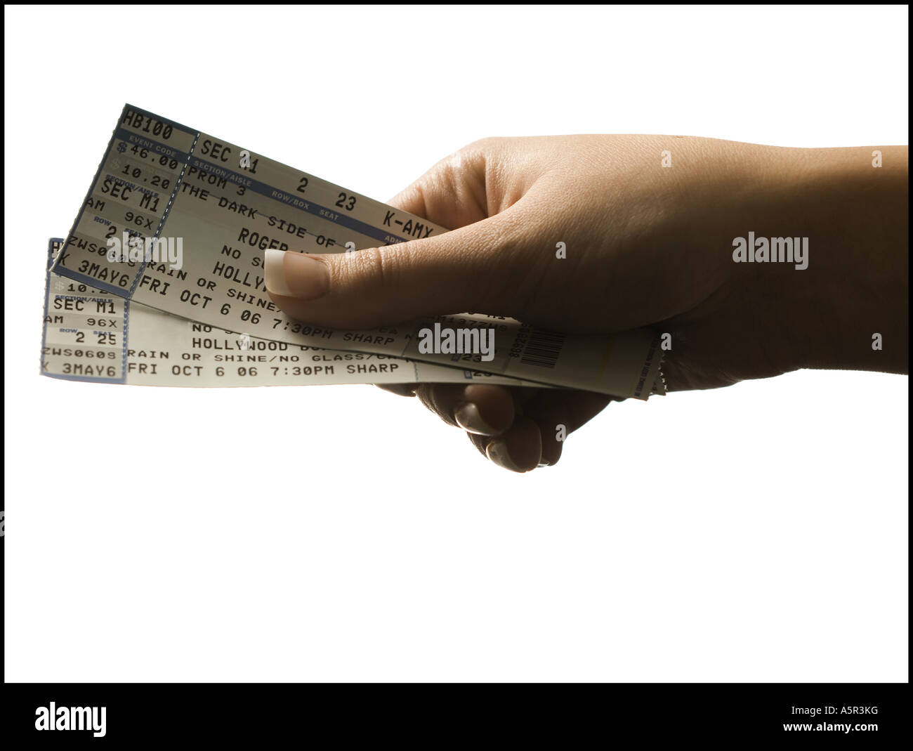 Woman holding concert tickets Stock Photo - Alamy