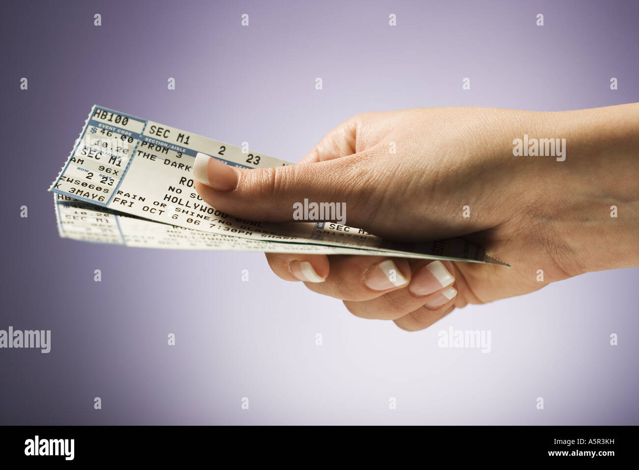 Woman holding concert tickets Stock Photo - Alamy