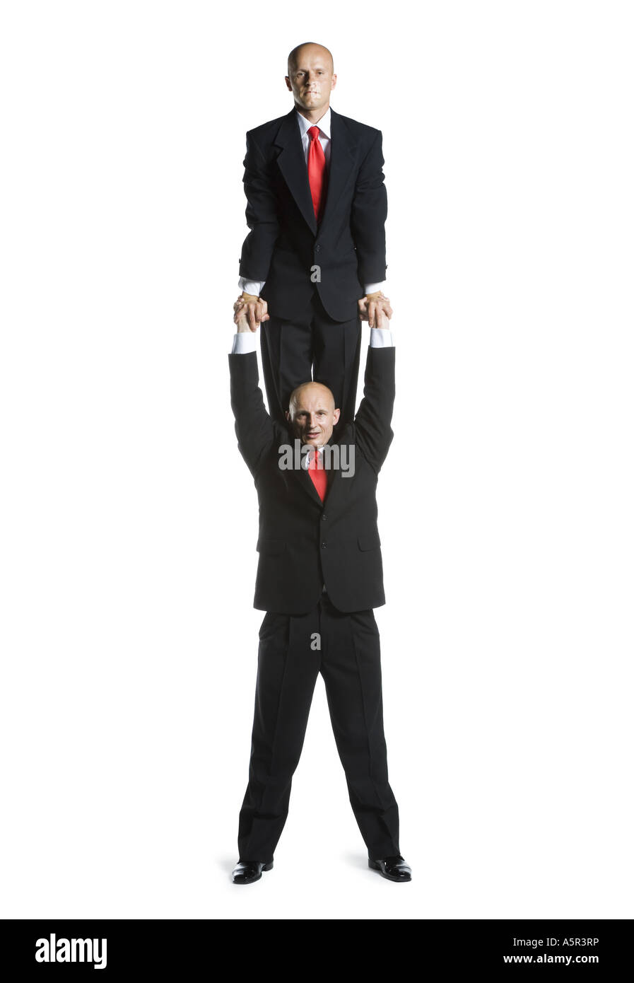 Portrait of two male acrobats in business suits performing Stock Photo ...