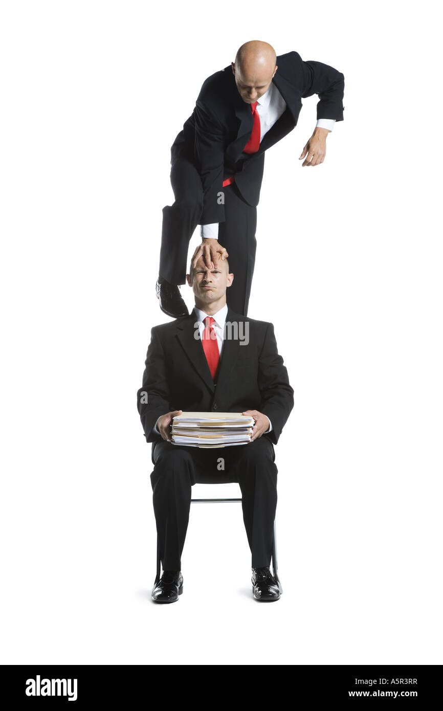 Two male acrobats in business suits performing Stock Photo - Alamy