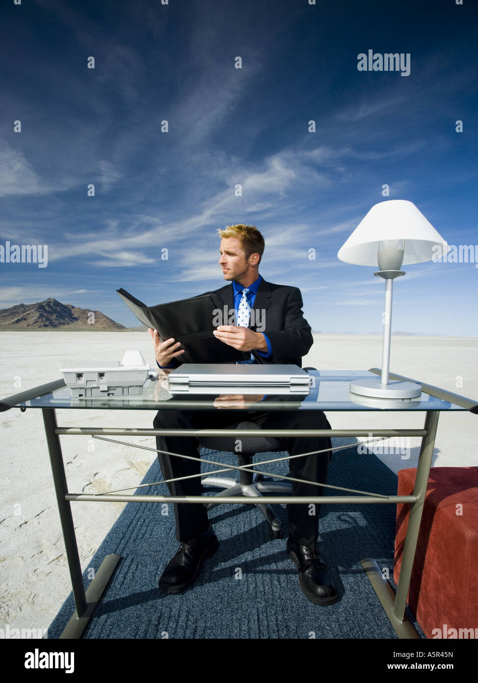 Businessman reading a file Stock Photo - Alamy