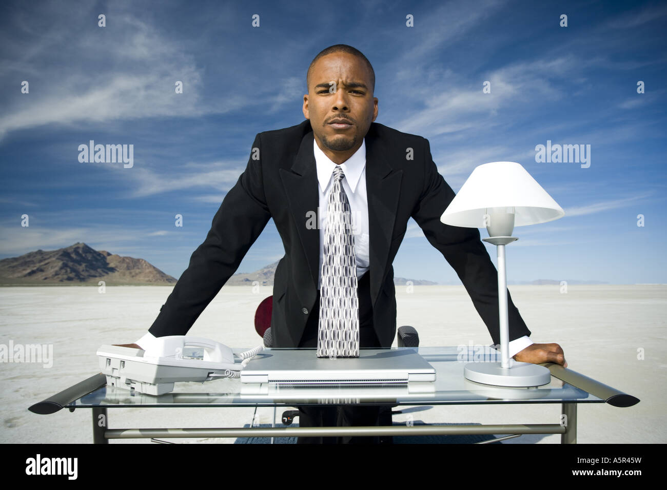 Portrait of a businessman leaning over a table Stock Photo - Alamy
