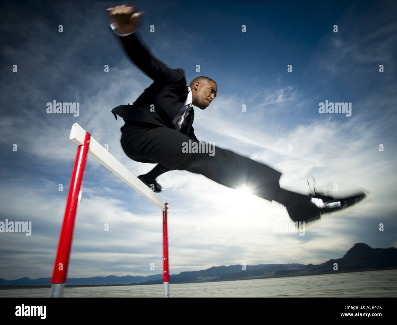 Businessman jumping over hurdle hi-res stock photography and images - Alamy