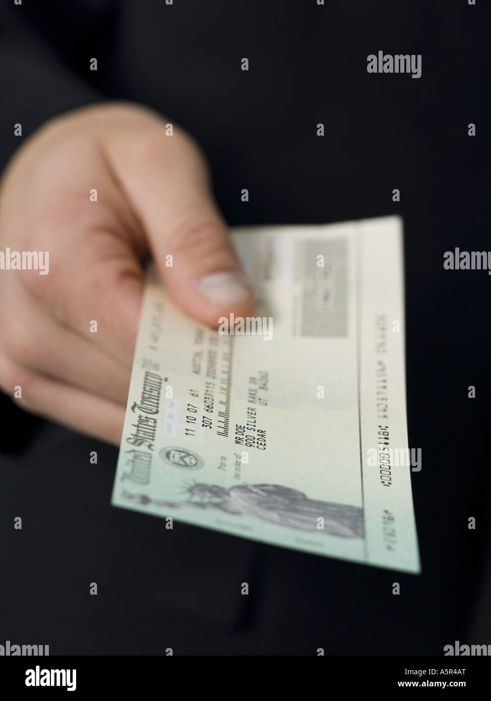 Businessman giving US check Stock Photo - Alamy