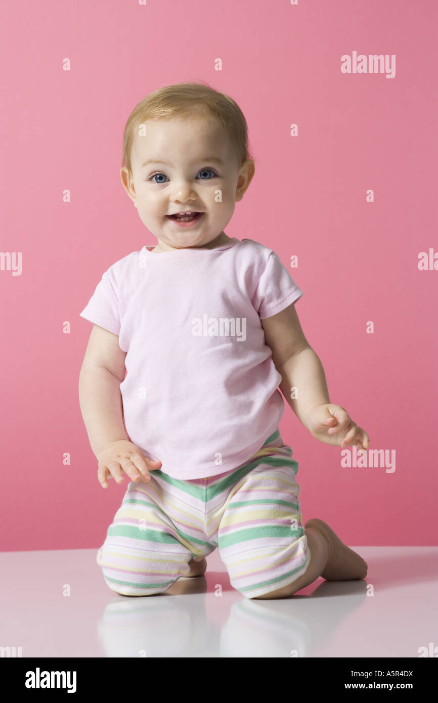 Baby Girl kneeling Stock Photo - Alamy