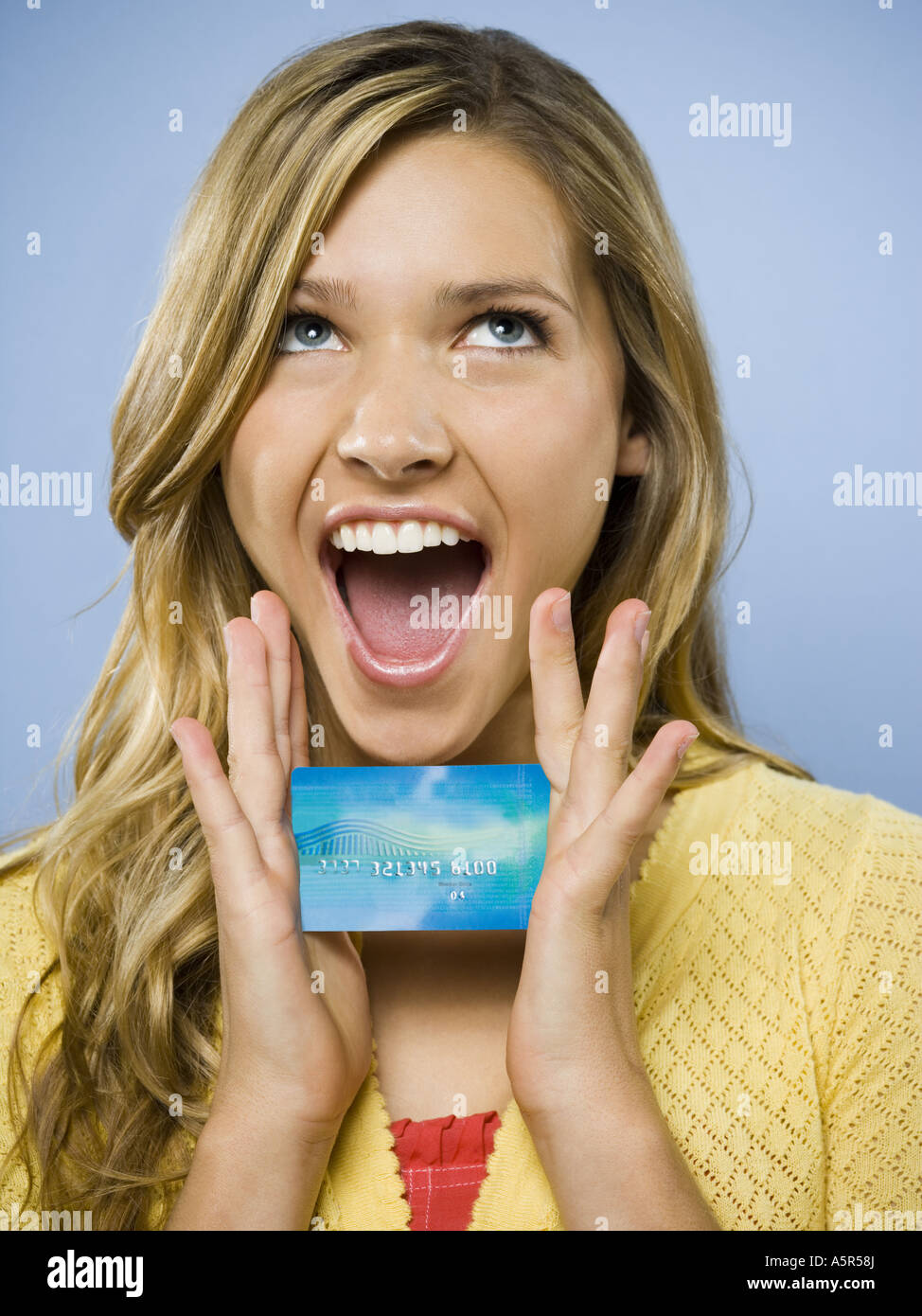 Excited woman with credit card Stock Photo - Alamy