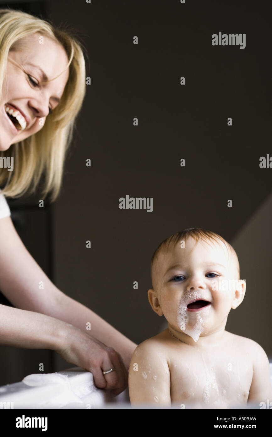 Woman bathing baby in sink Stock Photo - Alamy
