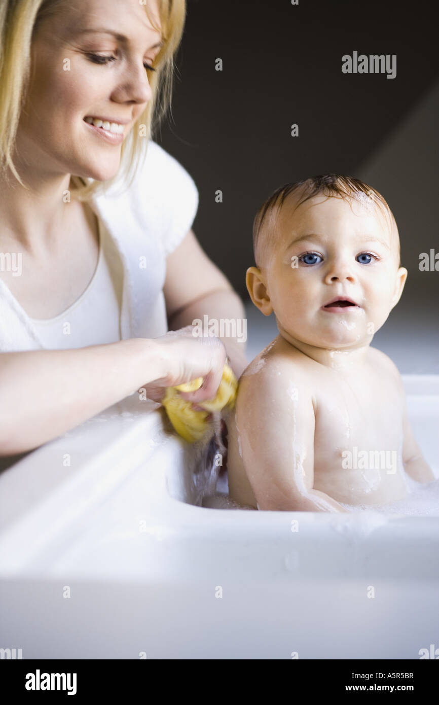 Woman bathing baby in sink Stock Photo - Alamy