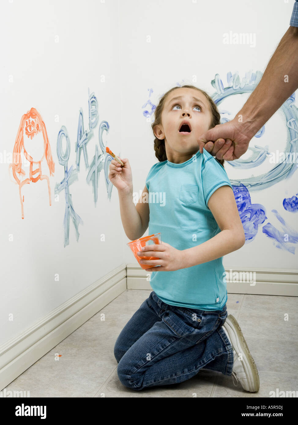 Close up of a man pulling a girl s top while painting on a wall Stock ...