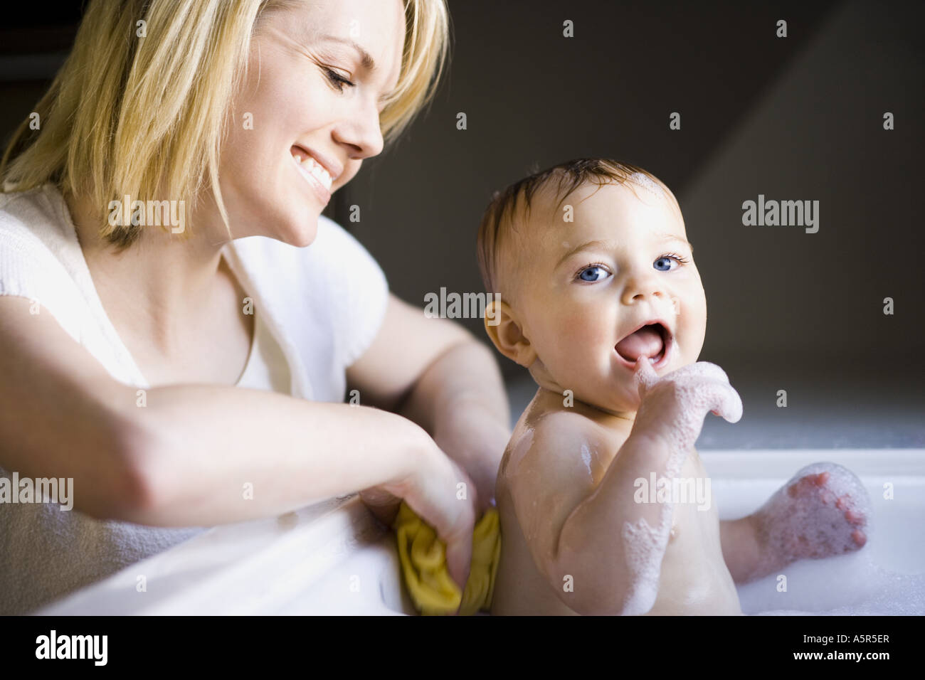 Woman bathing baby in sink hi-res stock photography and images - Alamy