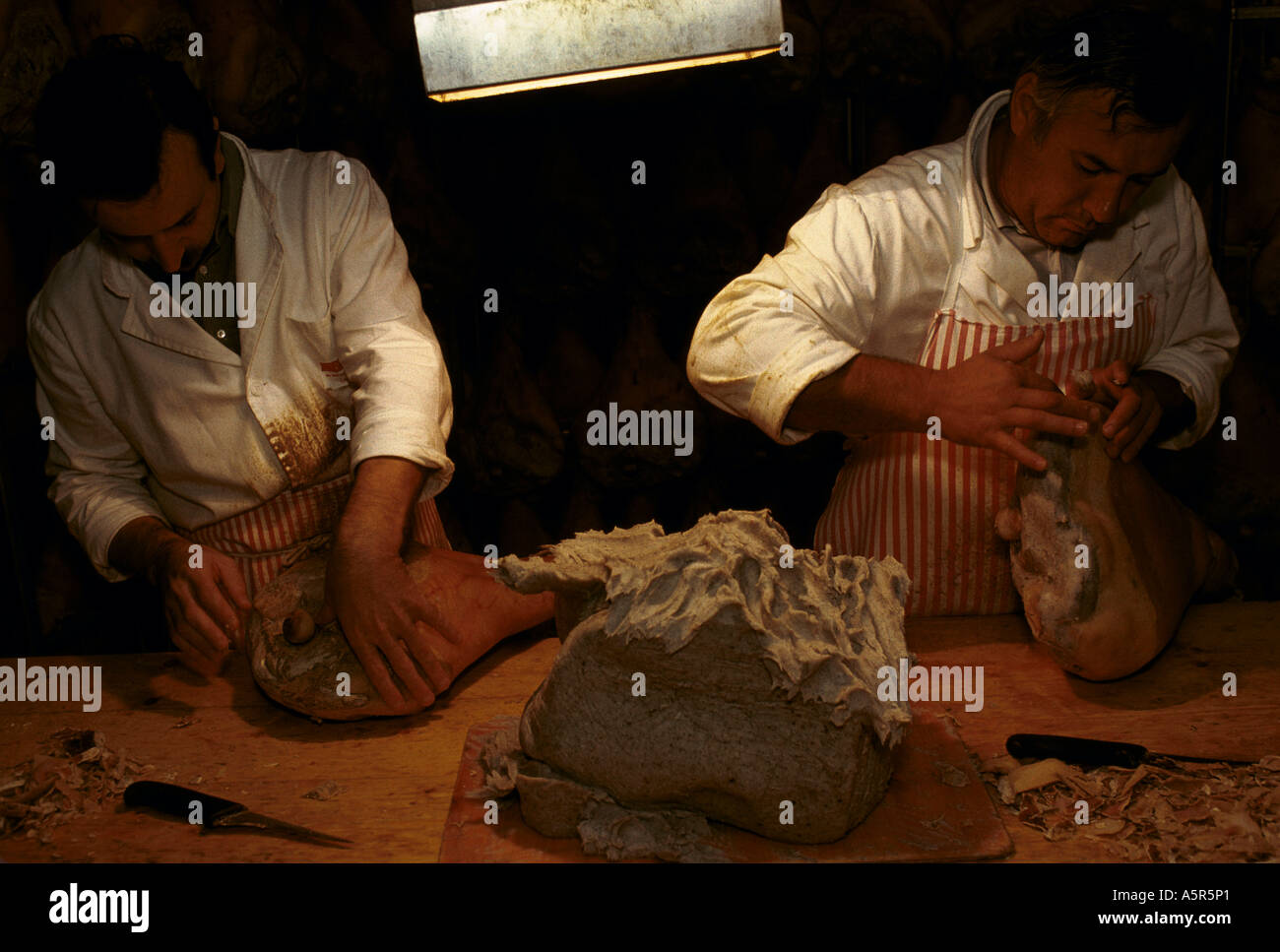 ITALIAN FOOD CURING PREPARATION OF PARMA HAM Stock Photo - Alamy