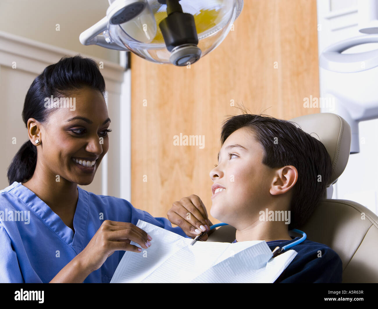 Boy at dentist with hygienist Stock Photo - Alamy