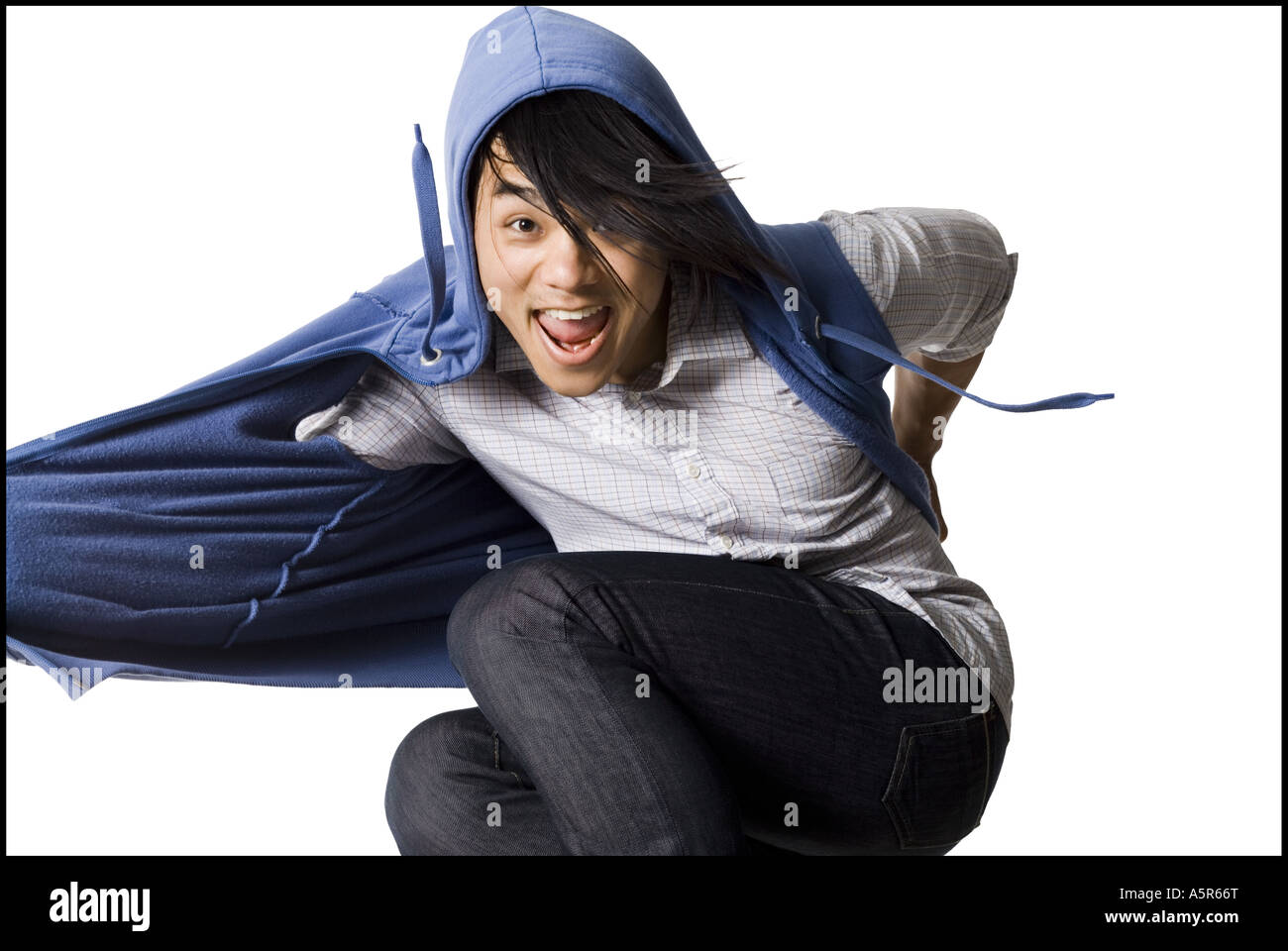 Man in hoodie dancing and smiling Stock Photo - Alamy