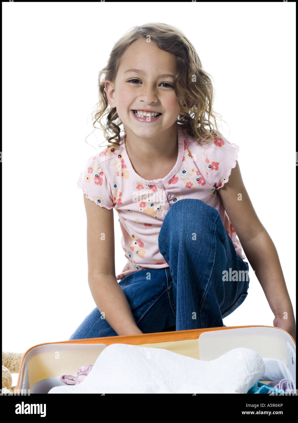 Portrait of a girl packing a suitcase Stock Photo - Alamy
