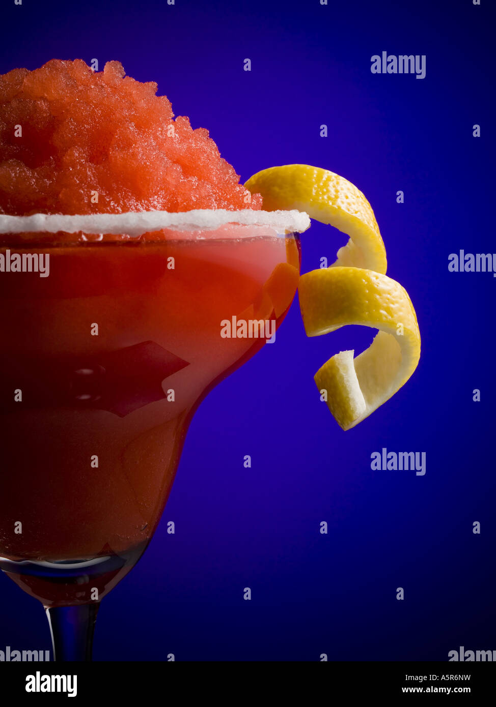 Red slush beverage in cocktail glass with lemon garnish Stock Photo - Alamy