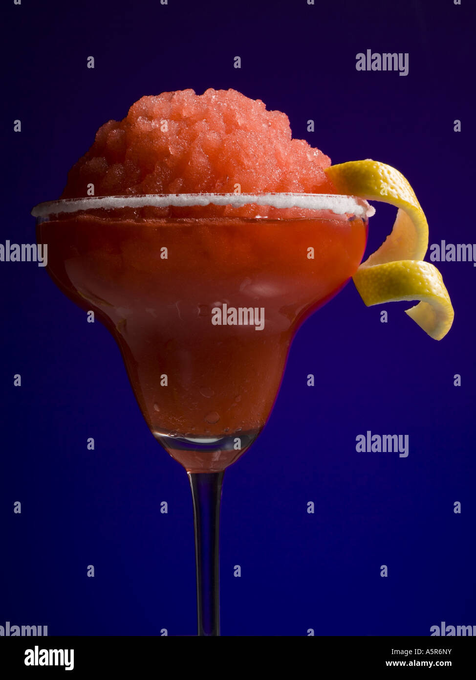 Red slush beverage in cocktail glass with lemon garnish Stock Photo - Alamy