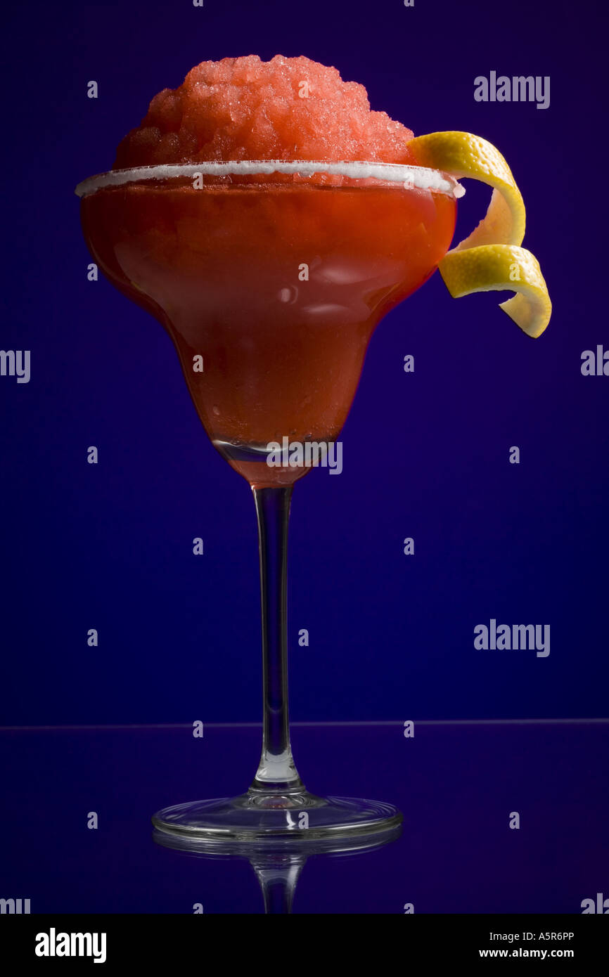 Red slush beverage in cocktail glass with lemon garnish Stock Photo - Alamy