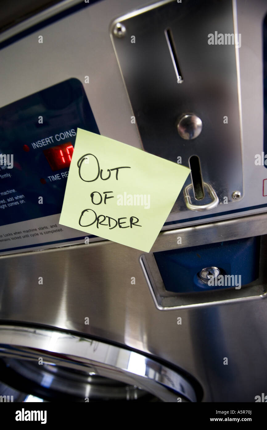 Out of order sign on Laundromat machine Stock Photo - Alamy