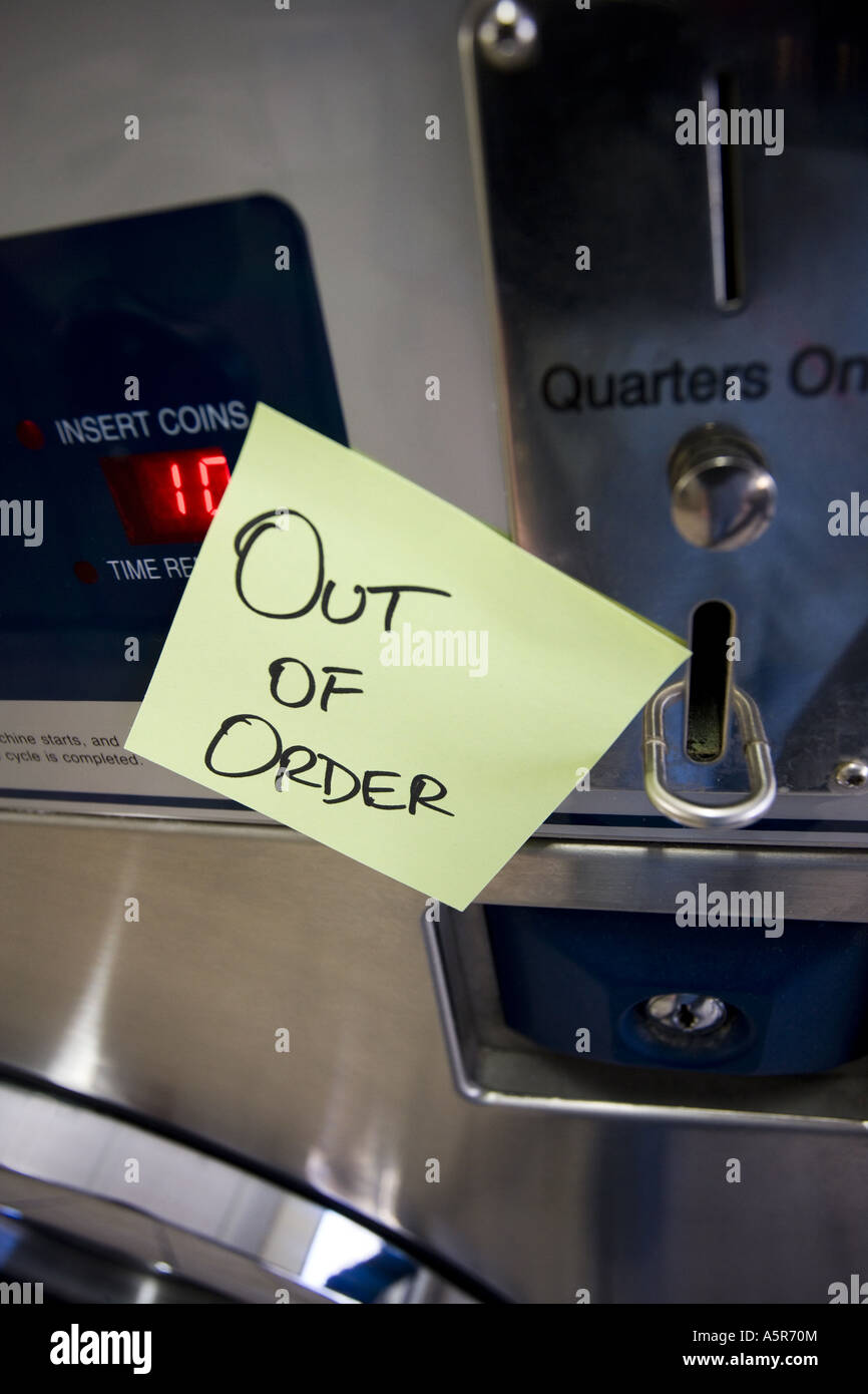 Out of order sign on Laundromat machine Stock Photo - Alamy