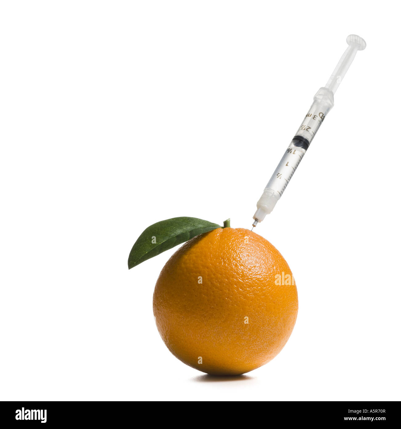Syringe in orange Stock Photo - Alamy