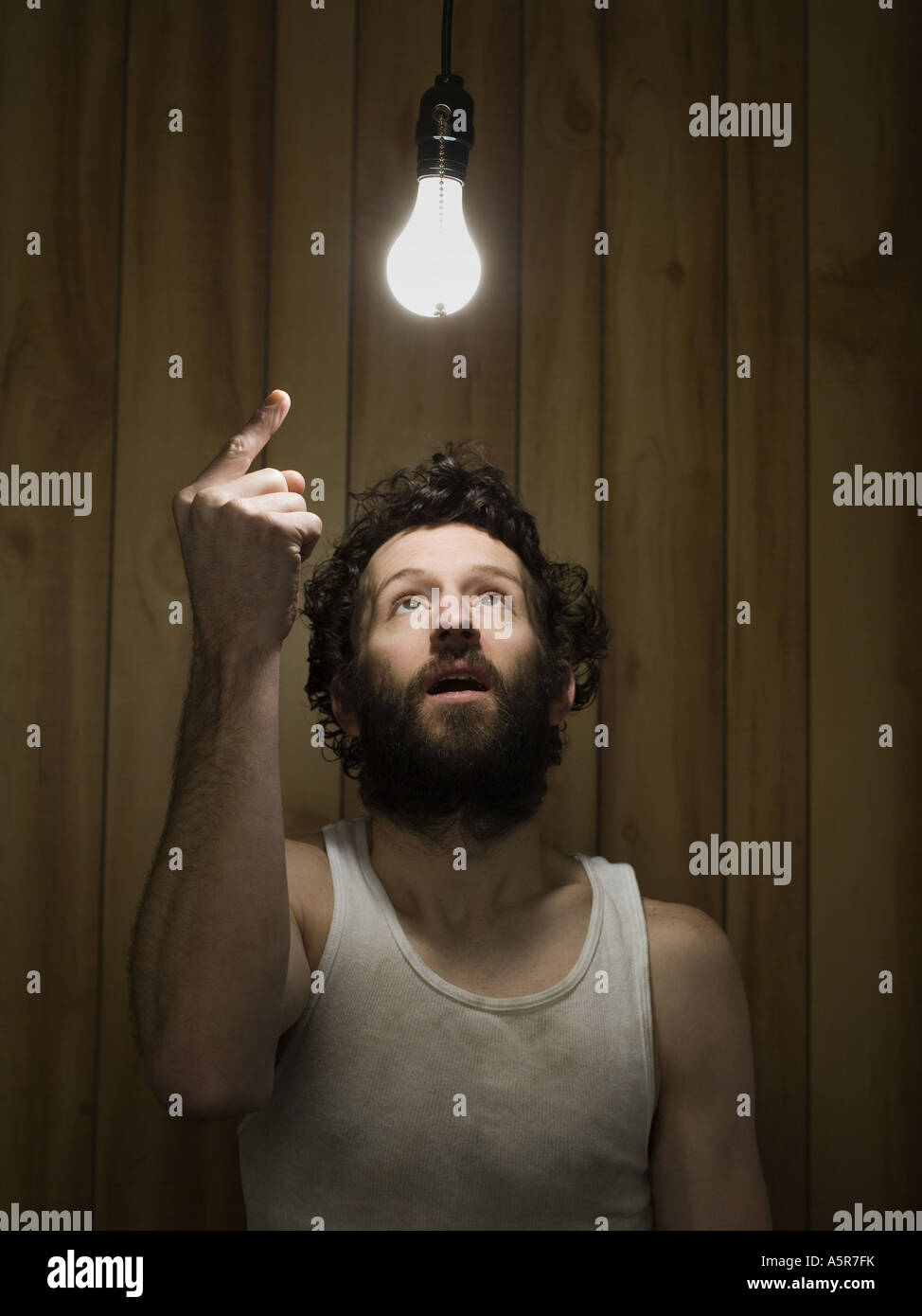Man reaching up to light bulb Stock Photo - Alamy