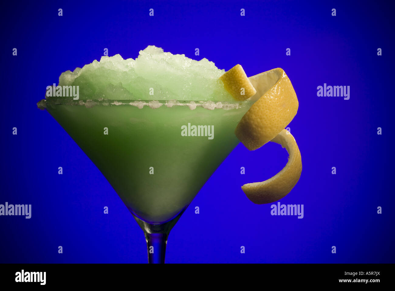 Green slush beverage in cocktail glass with lemon garnish Stock Photo ...