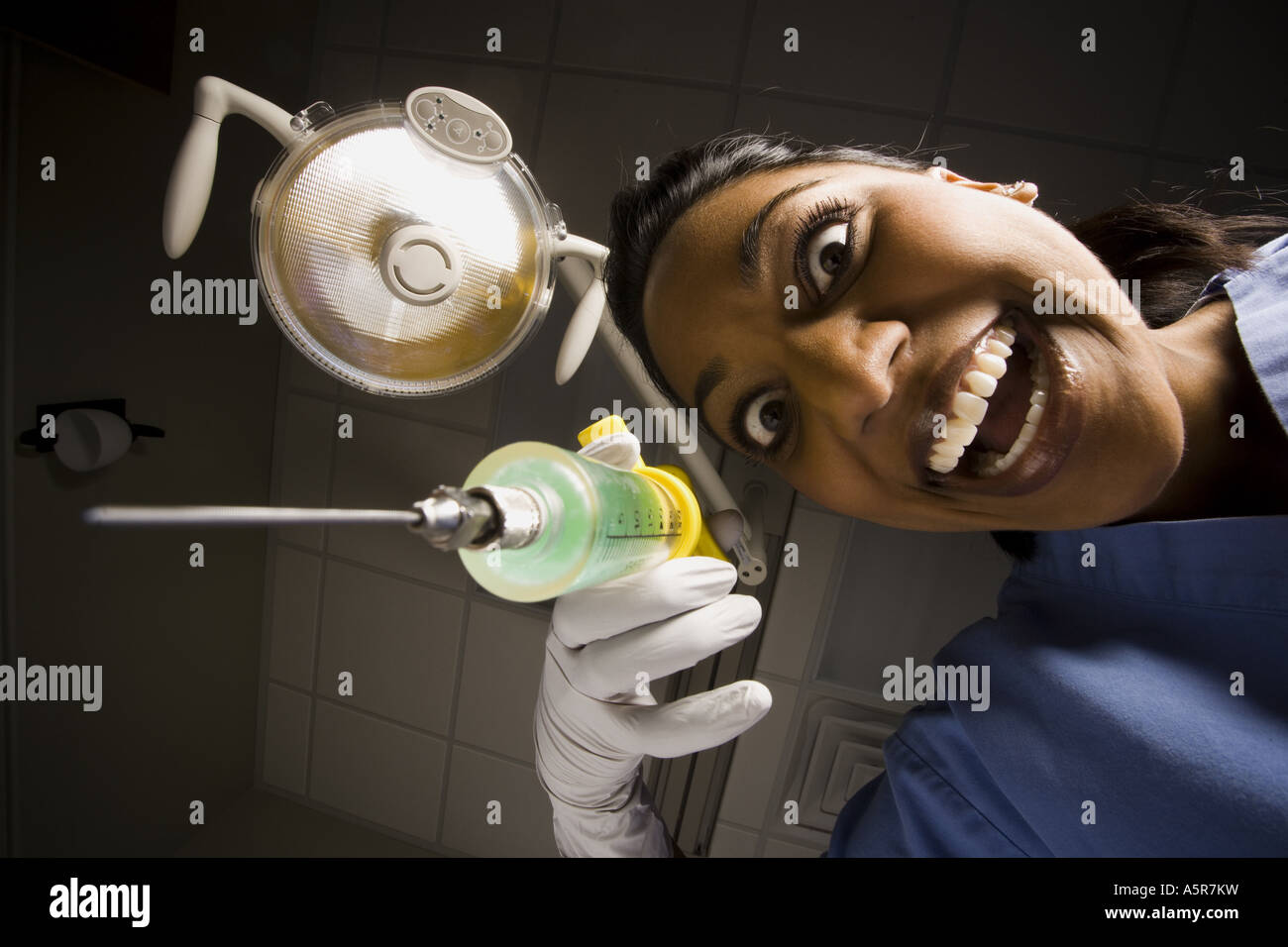 Dental hygienist with syringe dramatic angle Stock Photo - Alamy