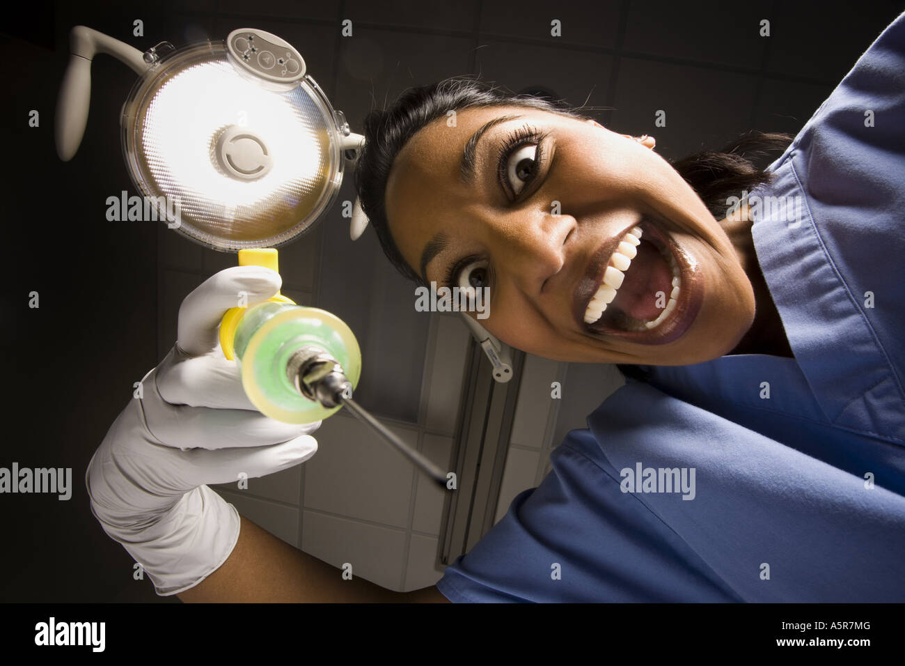Dental hygienist with syringe dramatic angle Stock Photo - Alamy