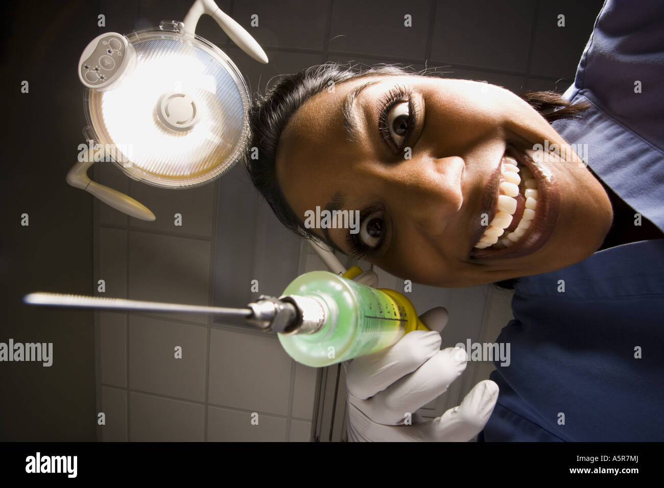 Dental hygienist with syringe dramatic angle Stock Photo - Alamy