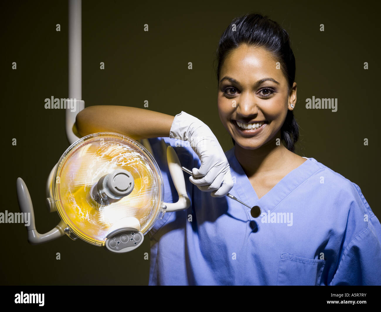 Woman in nurses uniform leaning on medical light Stock Photo - Alamy