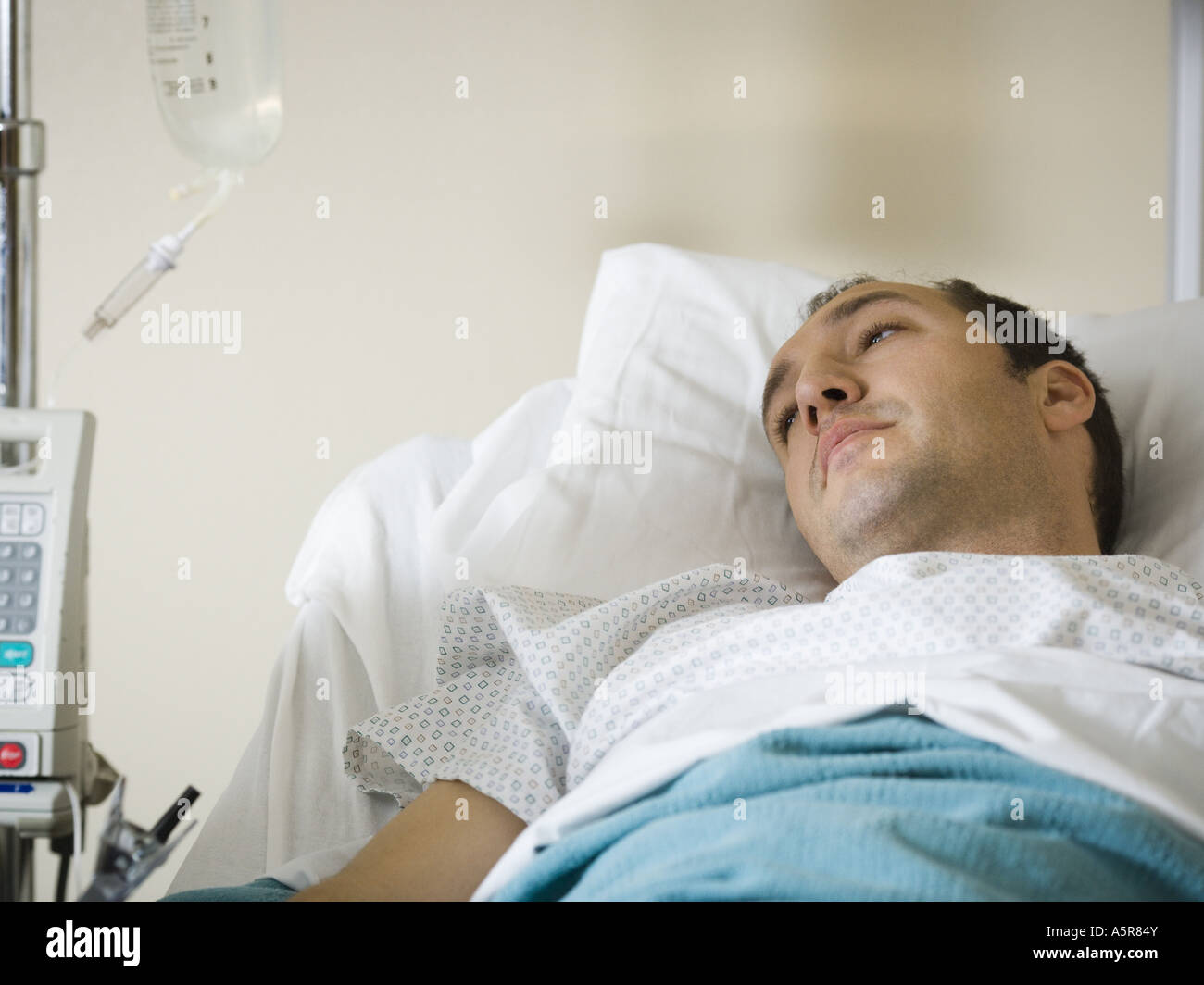 Male patient in hospital bed Stock Photo - Alamy