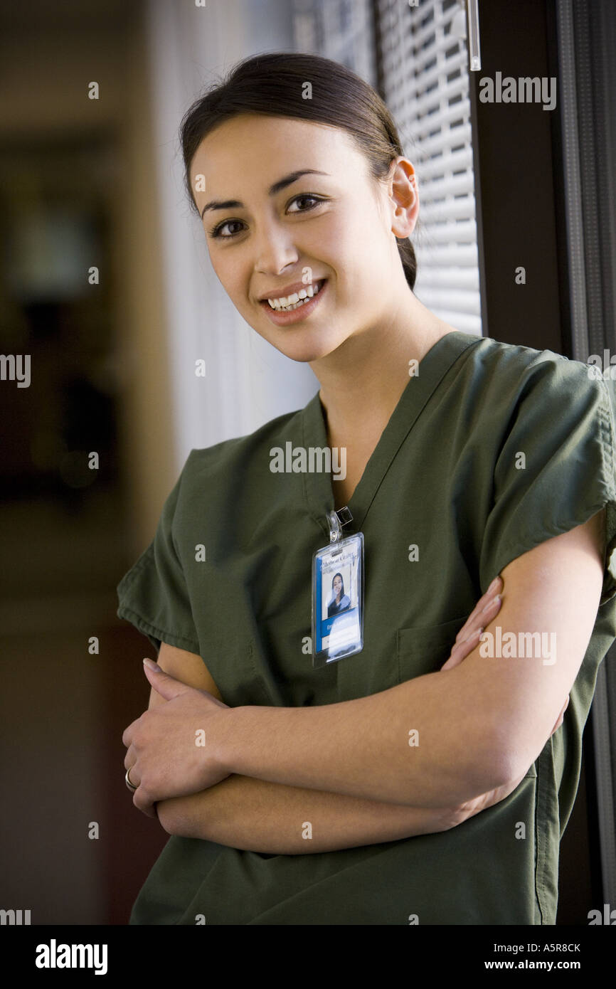 Portrait of a nurse with arms crossed smiling Stock Photo - Alamy